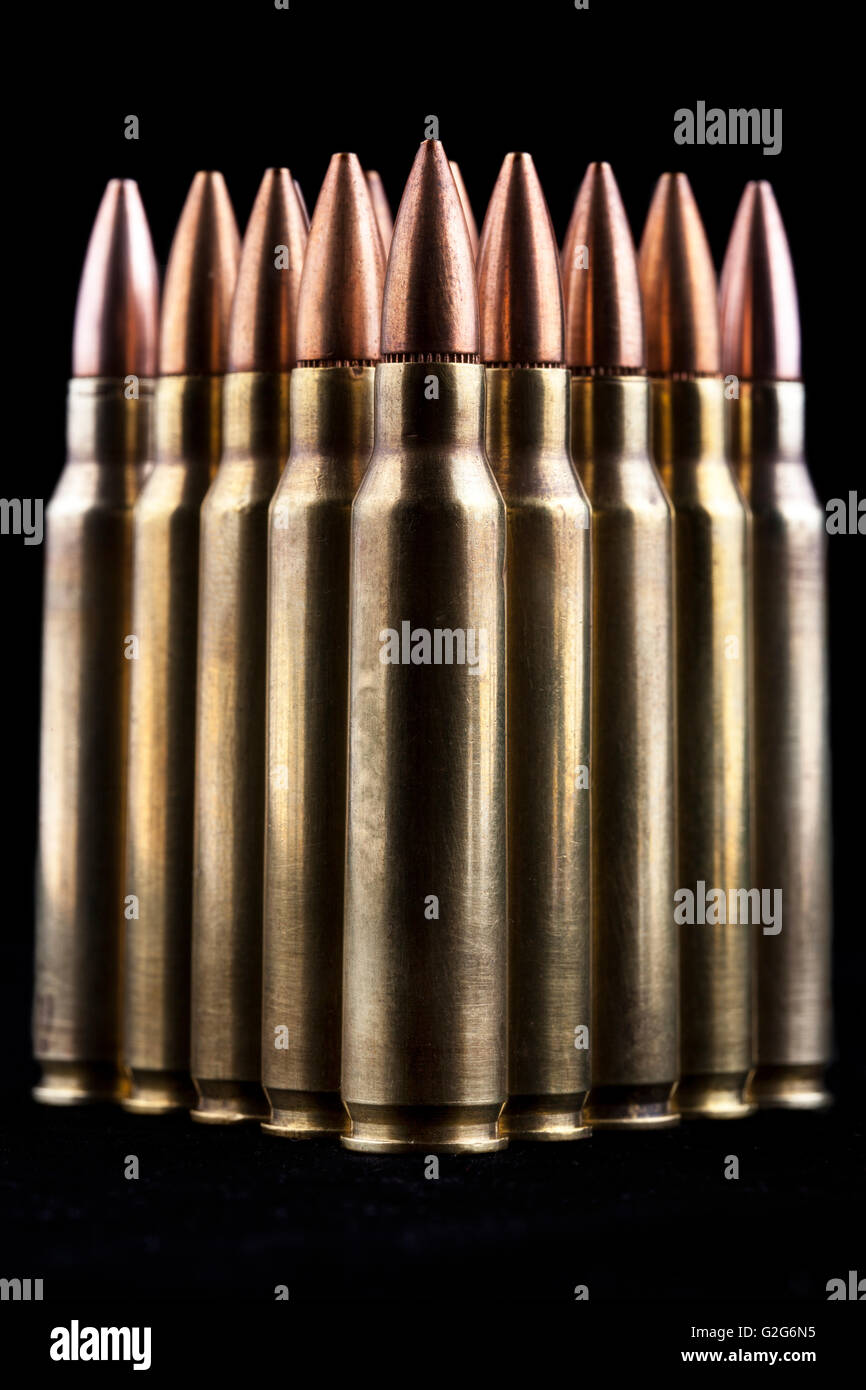 Shiny rifle bullets close-up on black background Stock Photo - Alamy