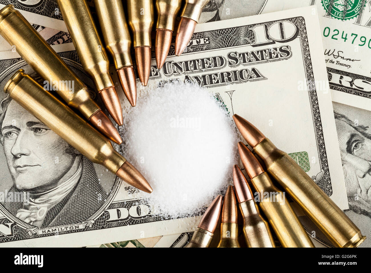 bullets on dollar banknotes with white drug powder Stock Photo - Alamy