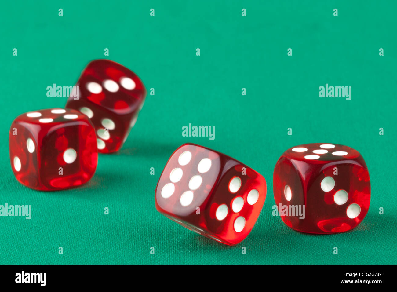 Four red bouncing dice On green background with some shadow Stock Photo ...