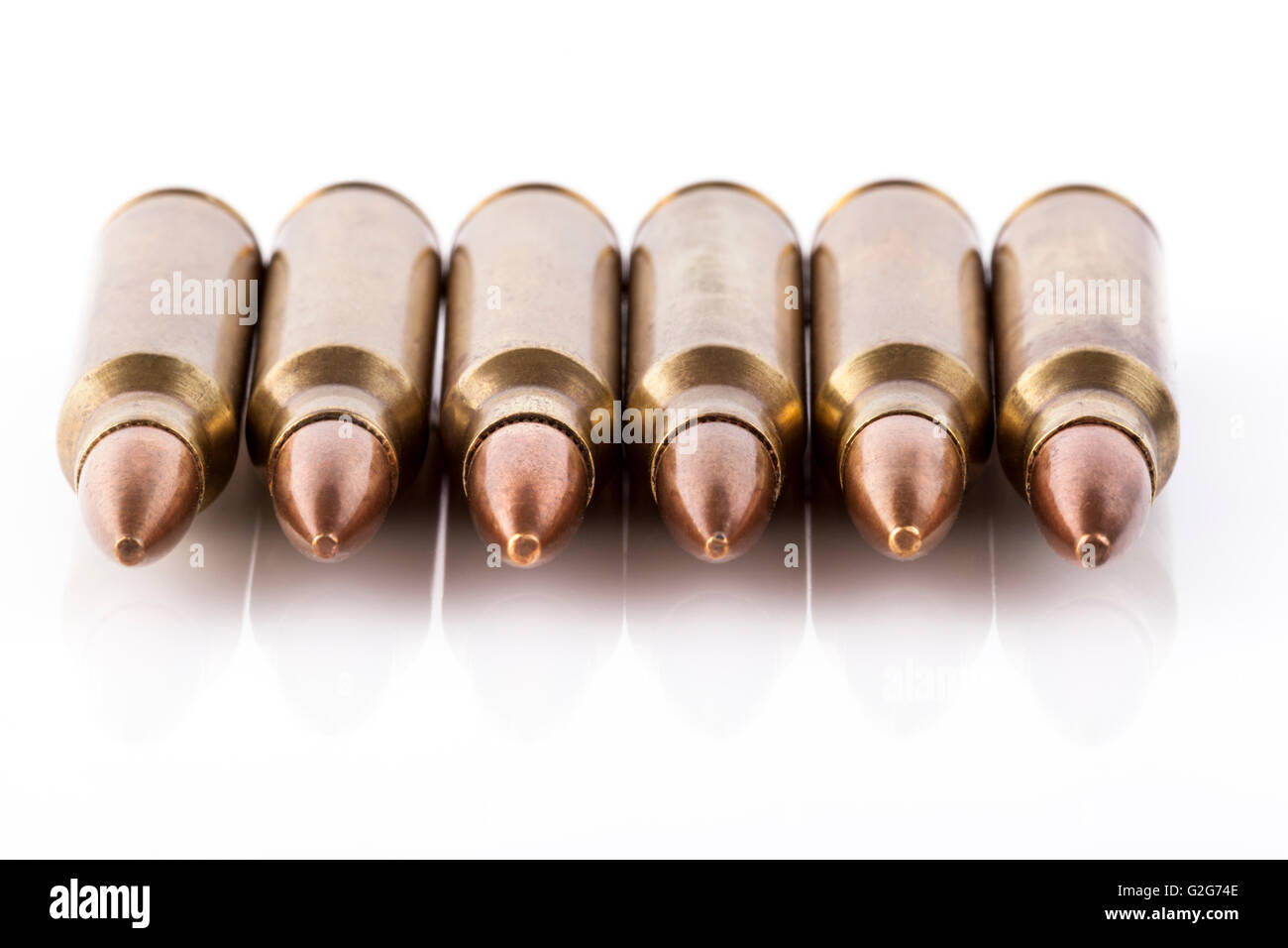 Six rifle bullets front isolated on white background with reflection ...