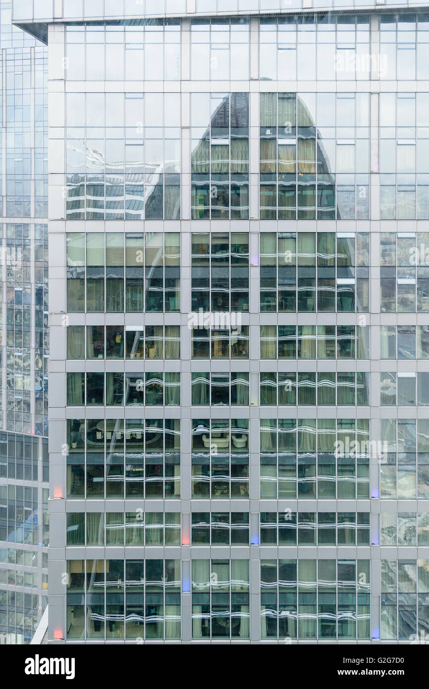 Wall of a skyscraper of glass and metal. View on the premises inside ...
