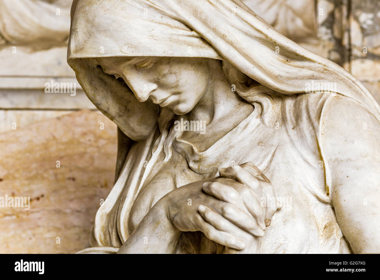 face of statue of grieving woman with her hands clasped in prayer Stock ...