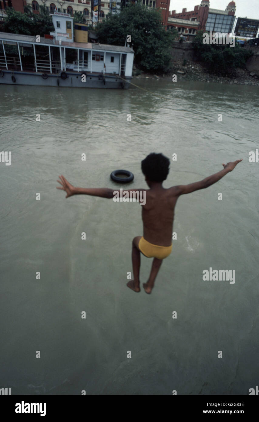 Boy jumping into the Ganges River, India Stock Photo - Alamy