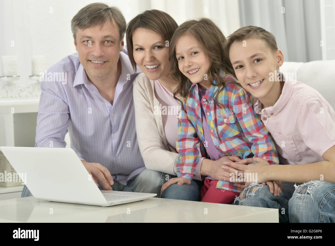 Happy family with laptop Stock Photo - Alamy