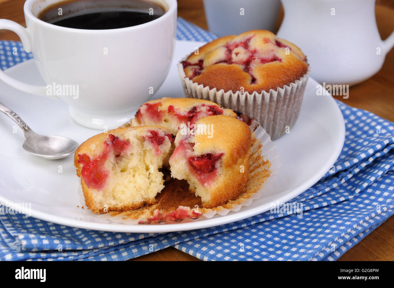 Break muffin with strawberries on a table cup of coffee Stock Photo - Alamy