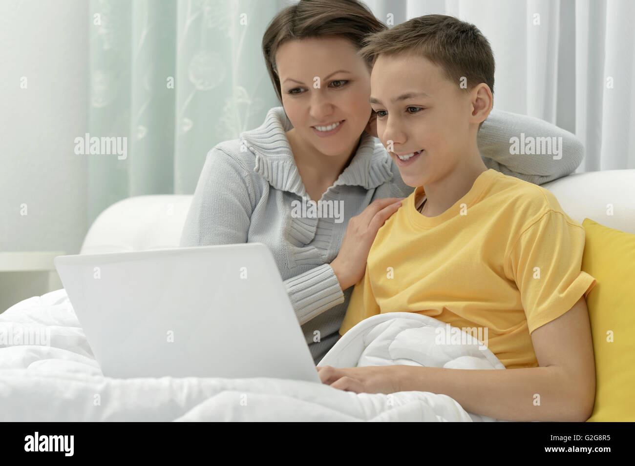 Mother and son using laptop Stock Photo - Alamy