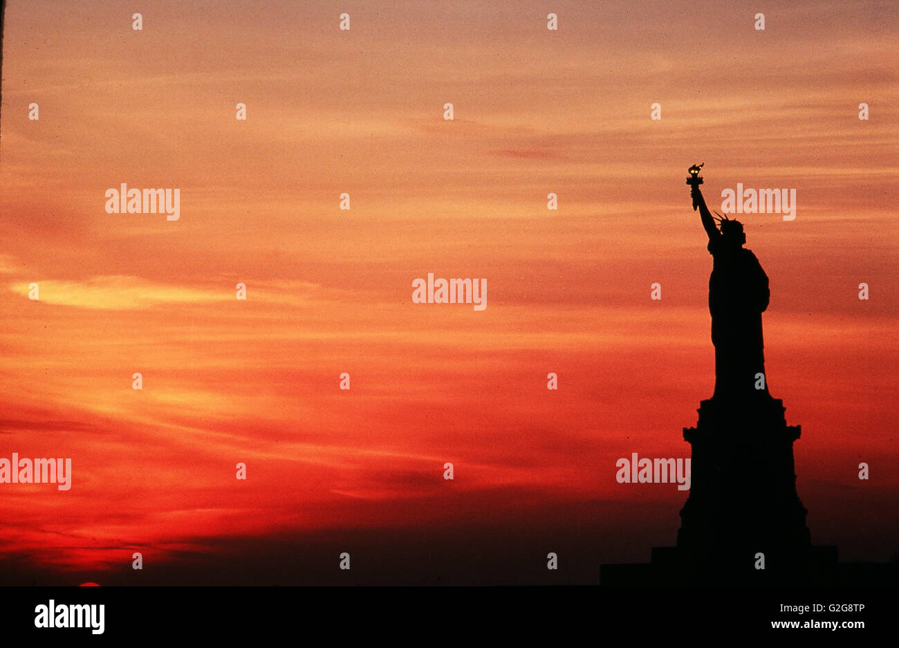 USA - New York. Statue of Liberty with red sky Stock Photo - Alamy