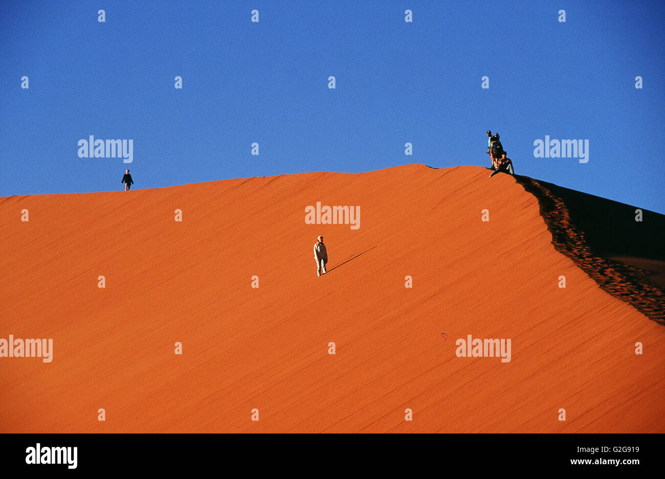 Namibia - Namib Desert. Tourist climb sand dune Stock Photo - Alamy