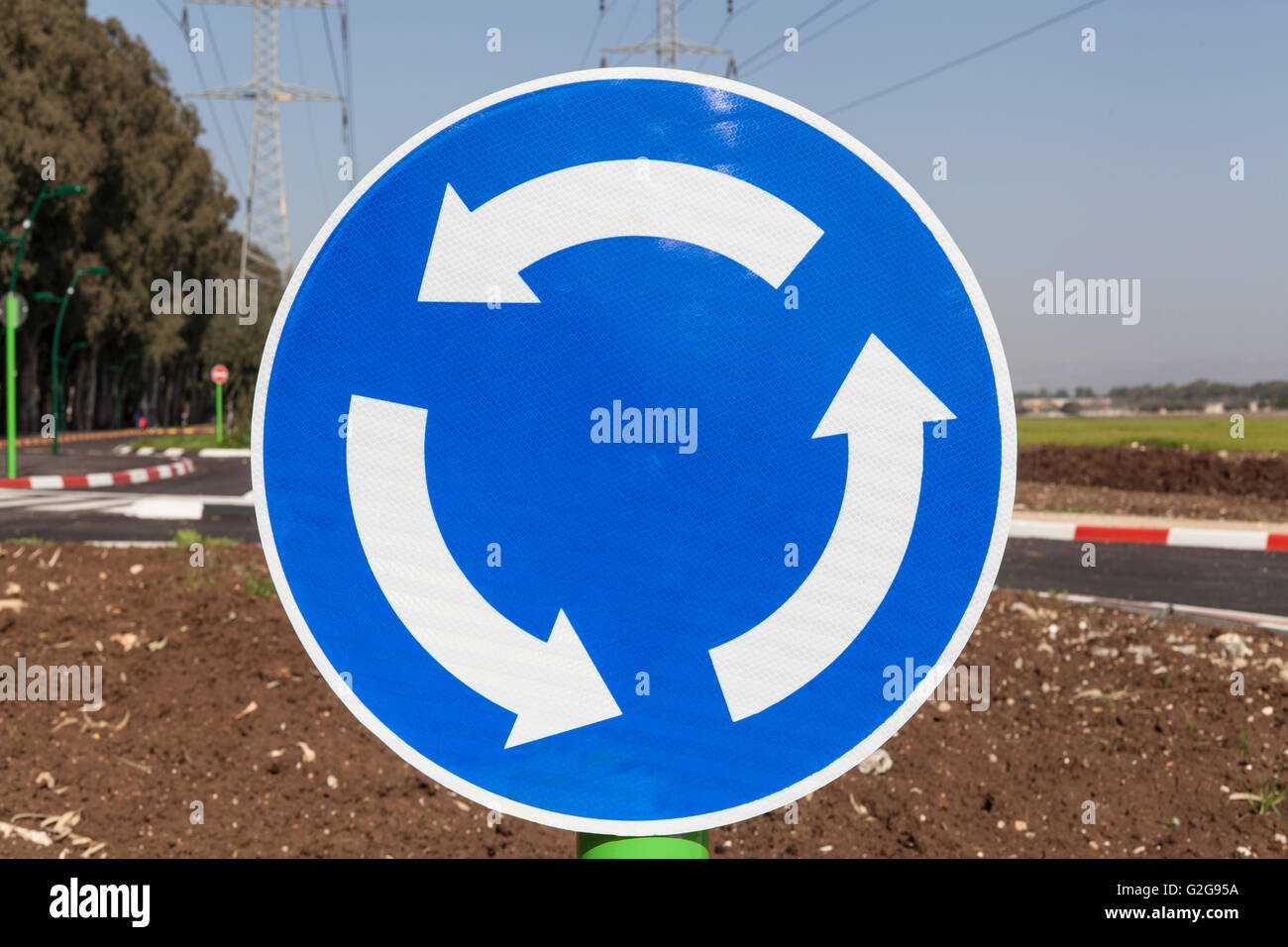 Roundabout blue traffic sign with background Stock Photo - Alamy