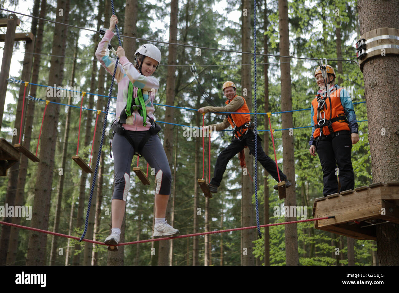 Woman climbing tree hi-res stock photography and images - Alamy