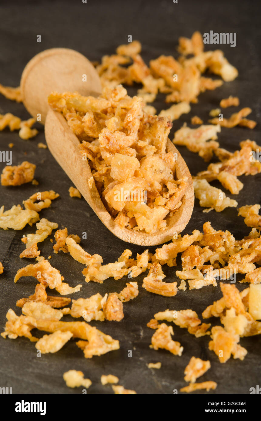 crispy onion and brown wooden shovel on slate Stock Photo - Alamy