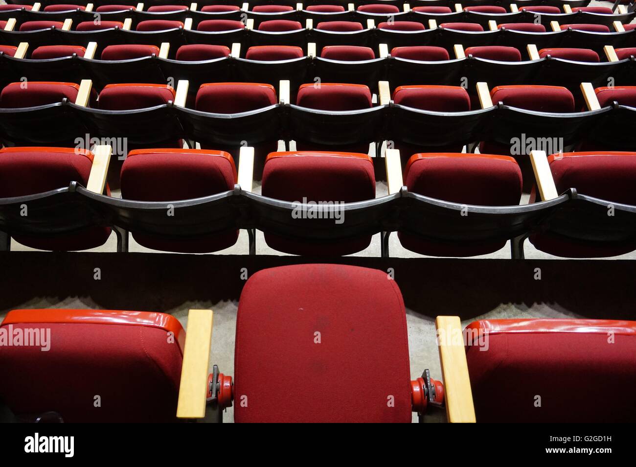 Folded red seats at a multipurpose arena and sports stadium Stock Photo ...