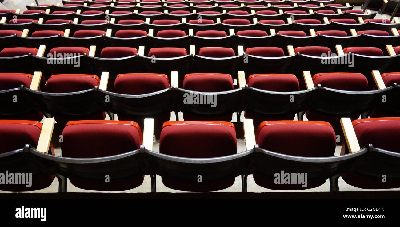 Folded red seats at a multipurpose arena and sports stadium Stock Photo ...