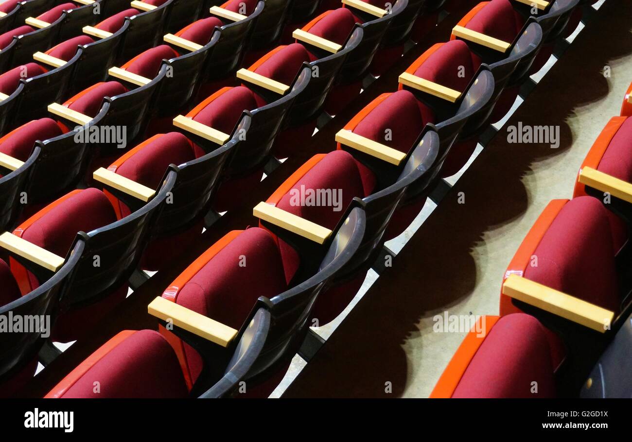 Folded red seats at a multipurpose arena and sports stadium Stock Photo ...