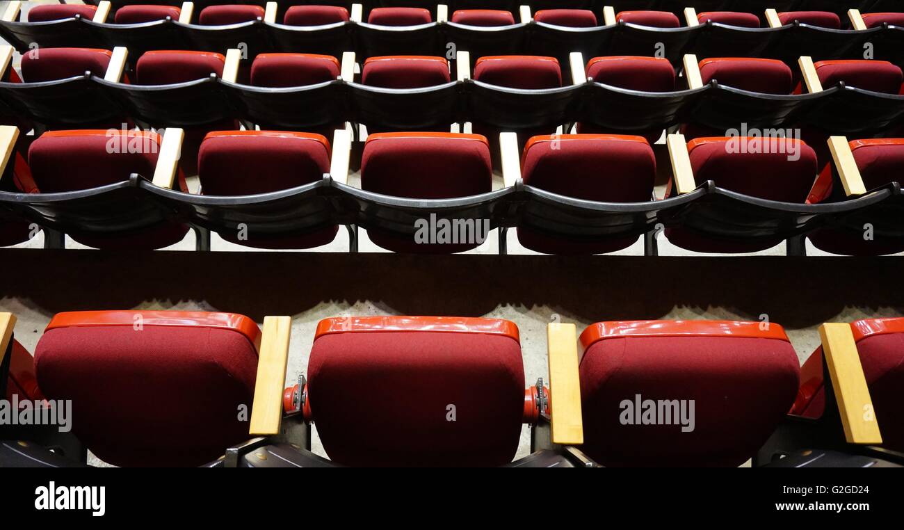 Folded red seats at a multipurpose arena and sports stadium Stock Photo ...