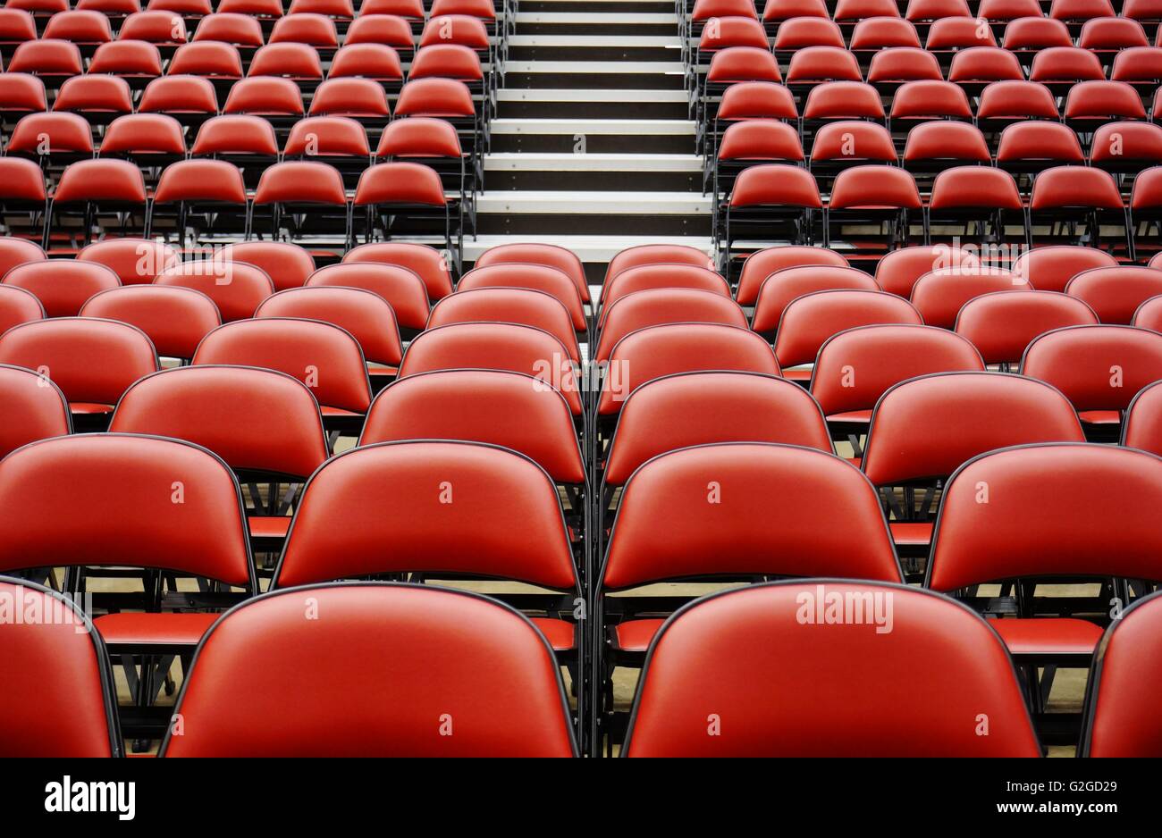 Folded red seats at a multipurpose arena and sports stadium Stock Photo ...