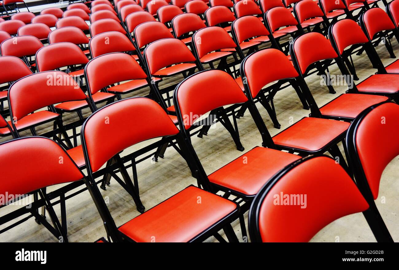Folded red seats at a multipurpose arena and sports stadium Stock Photo ...