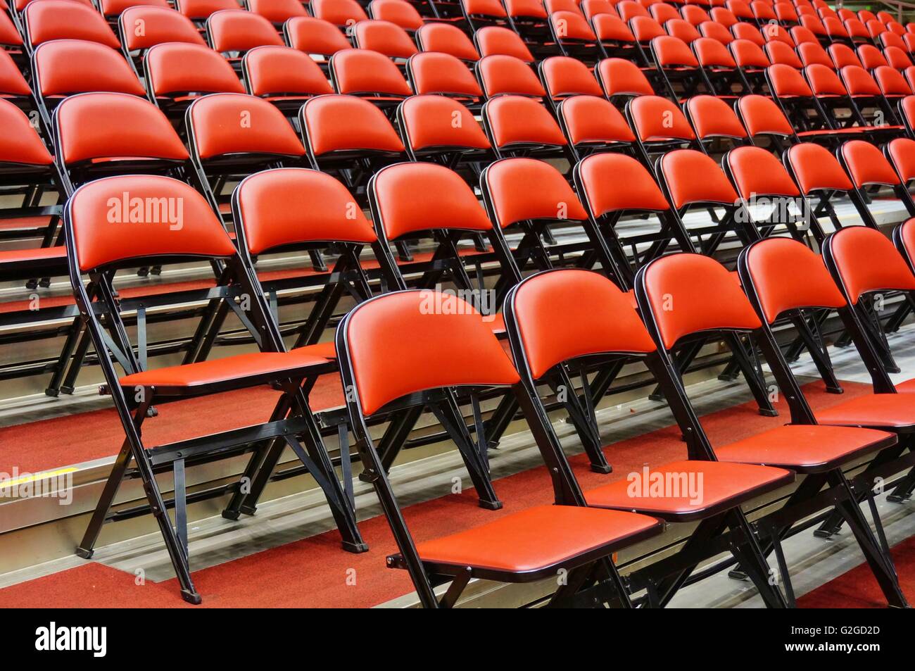 Folded red seats at a multipurpose arena and sports stadium Stock Photo ...