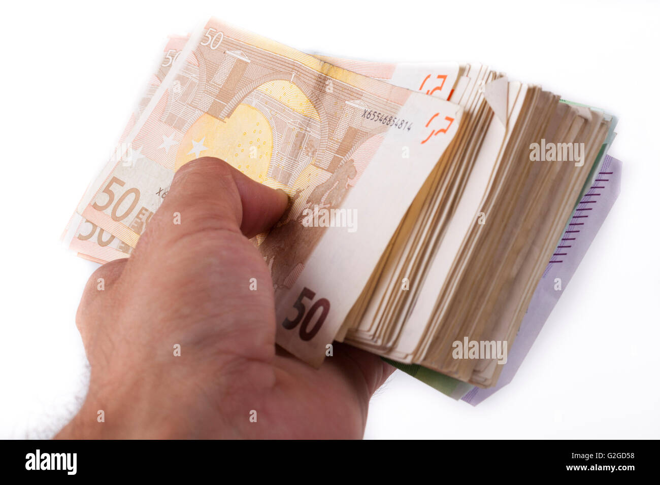 Man hand holding a bunch of euro banknotes isolated on white background ...