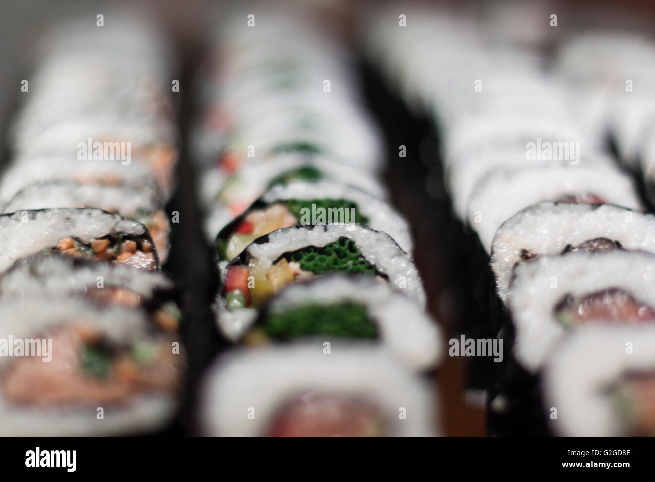 Sushi rows wit white rise and green herbs Stock Photo - Alamy