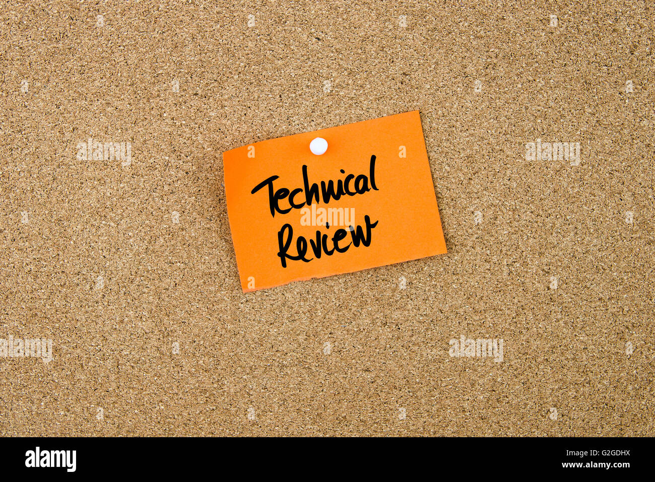 Technical Review written on orange paper note pinned on cork board with ...