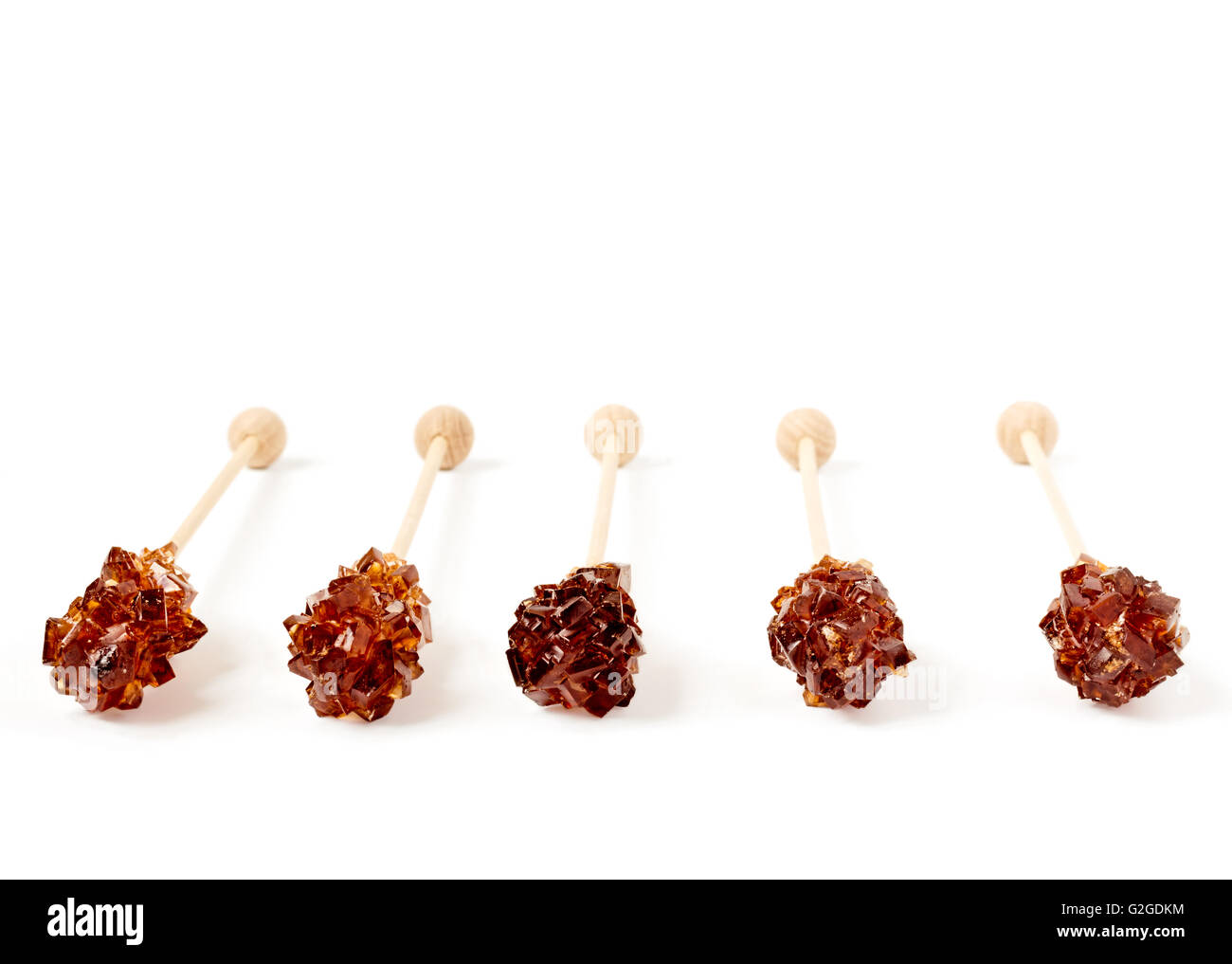 Five brown sugar stirrers isolated on white Stock Photo - Alamy
