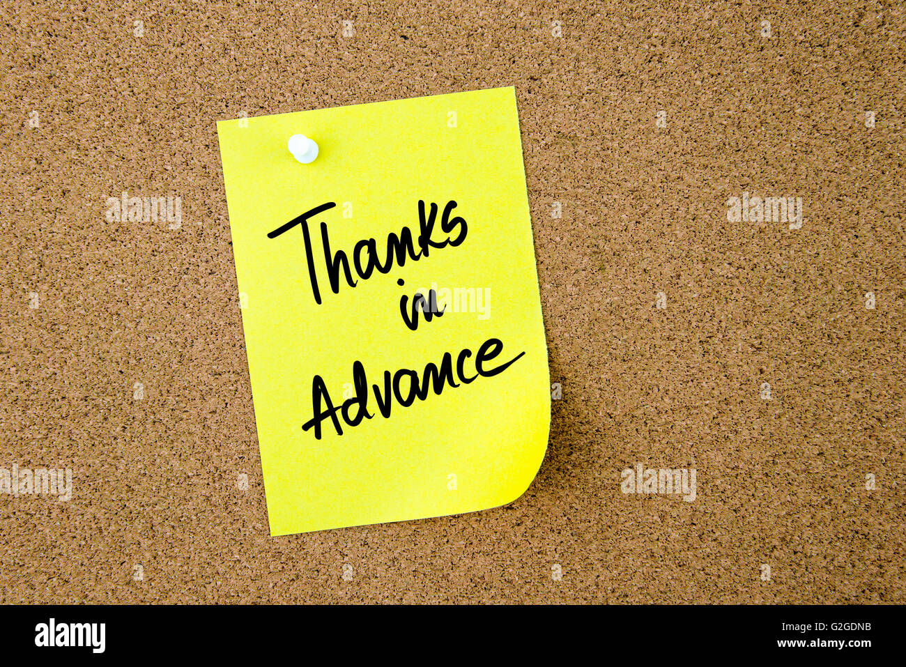 Thanks In Advance written on yellow paper note pinned on cork board ...