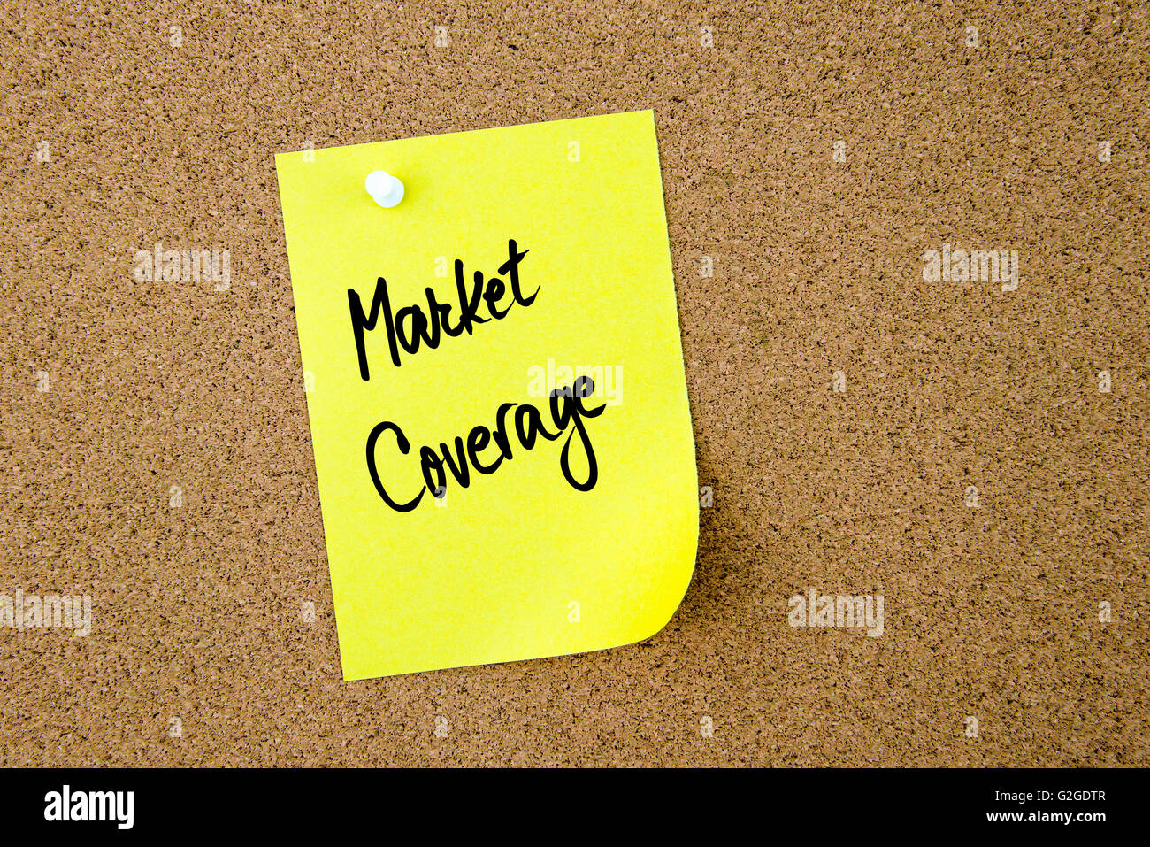 Market Coverage written on yellow paper note pinned on cork board with ...