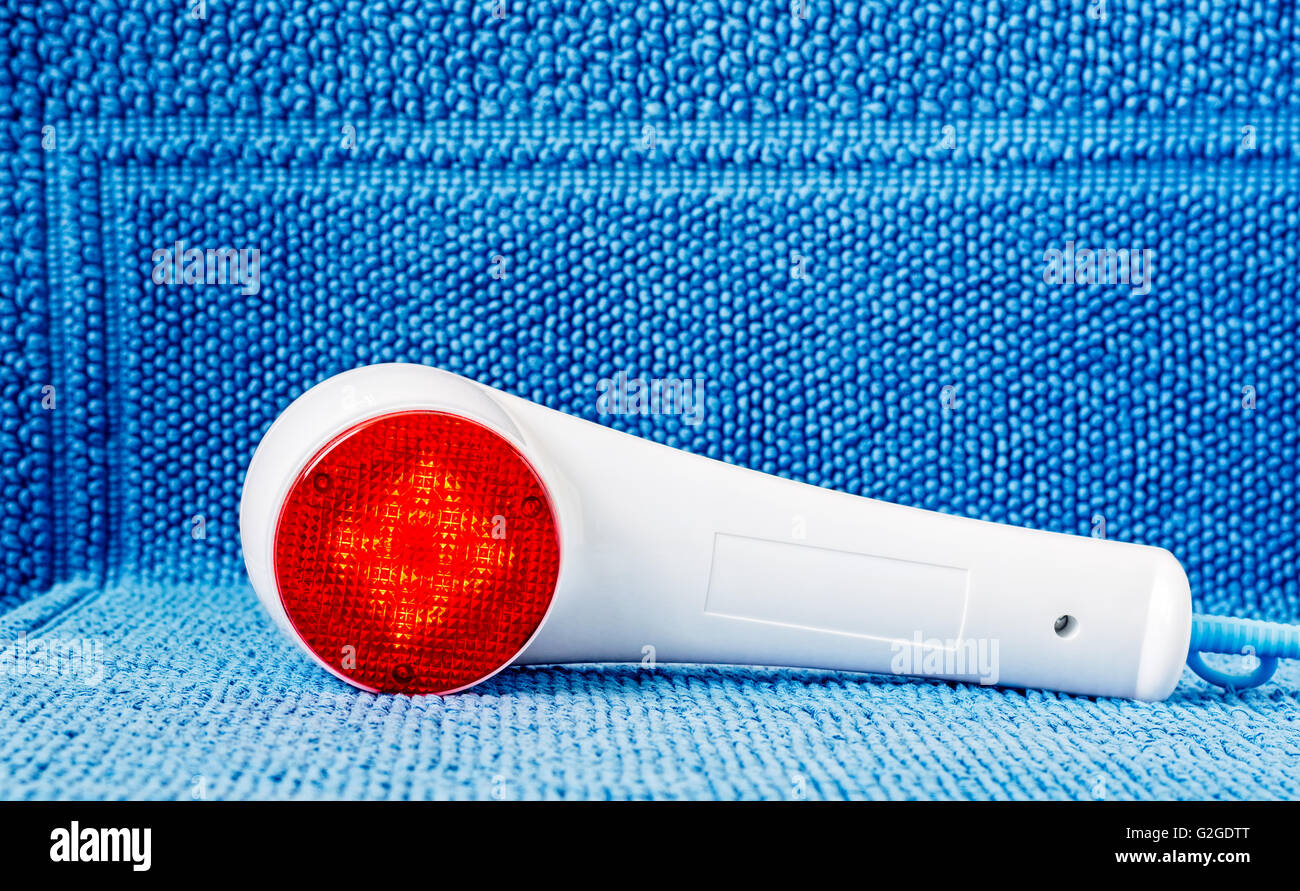 Infrared hand held massager turned on Stock Photo - Alamy
