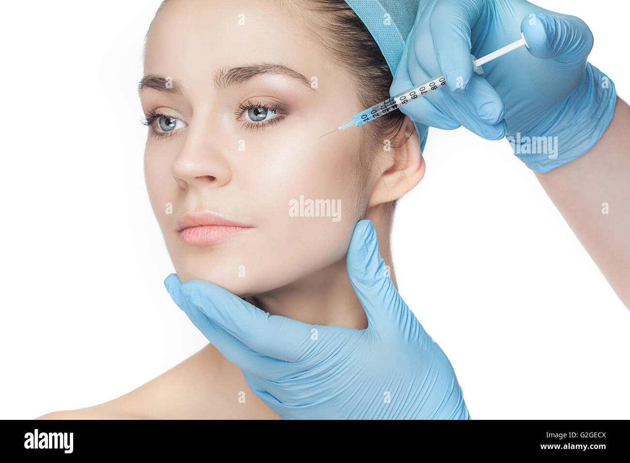 Attractive woman at plastic surgery with syringe in her face Stock ...