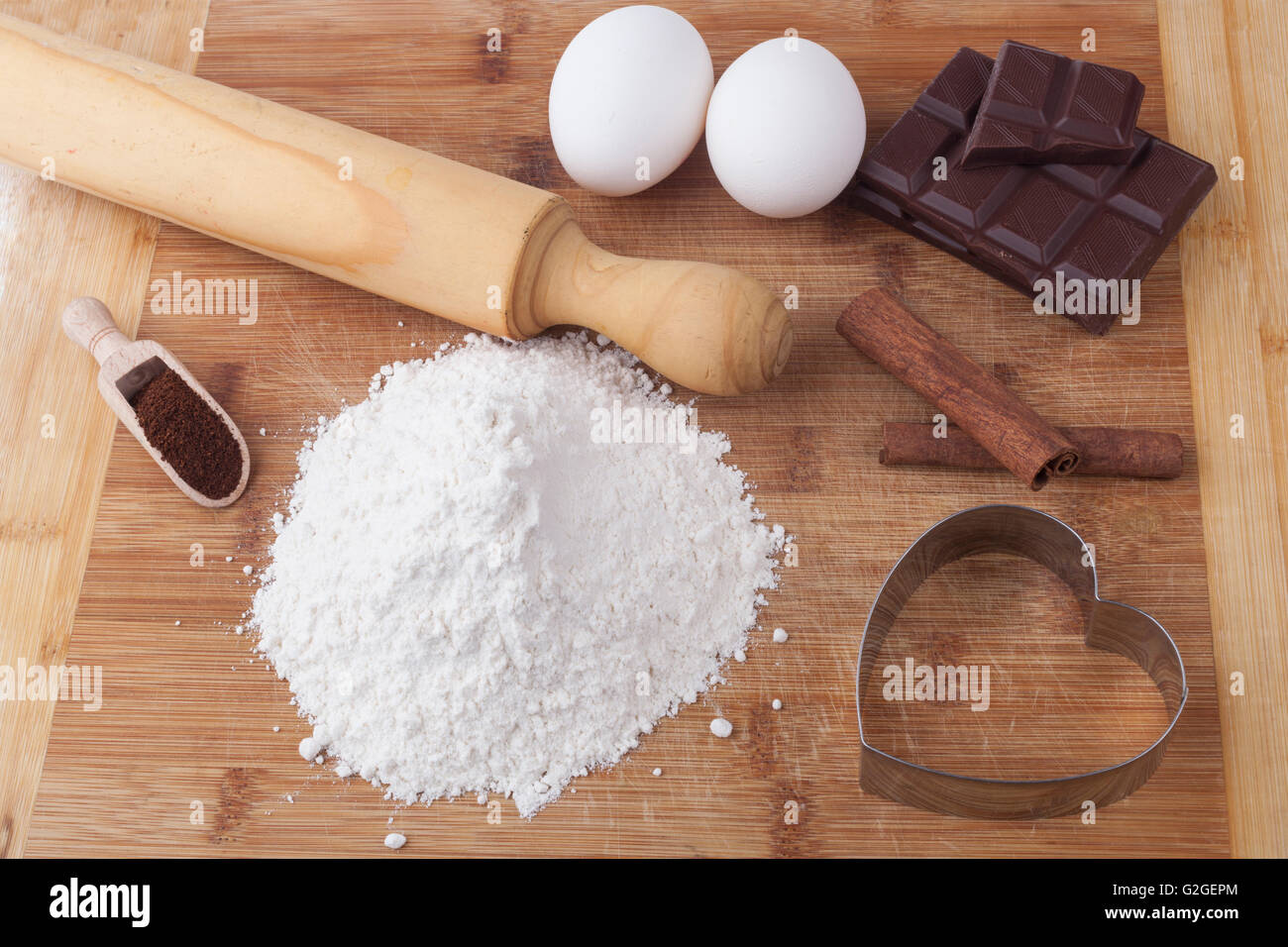 Baking ingredients and tools on brown wood cutting board Stock Photo ...