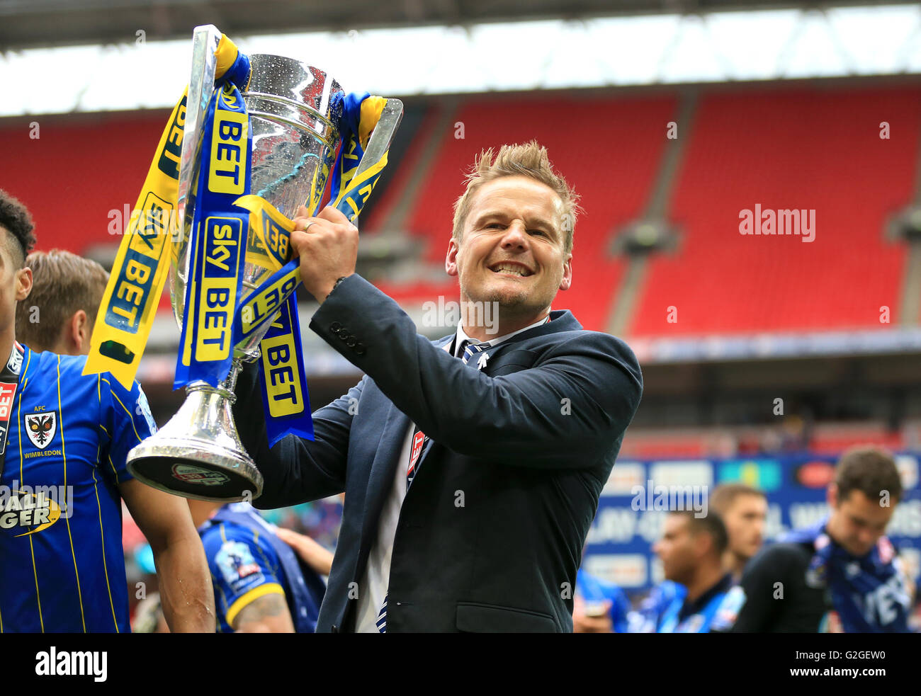 AFC Wimbledon manager Neal Ardley celebrates with the trophy after his ...