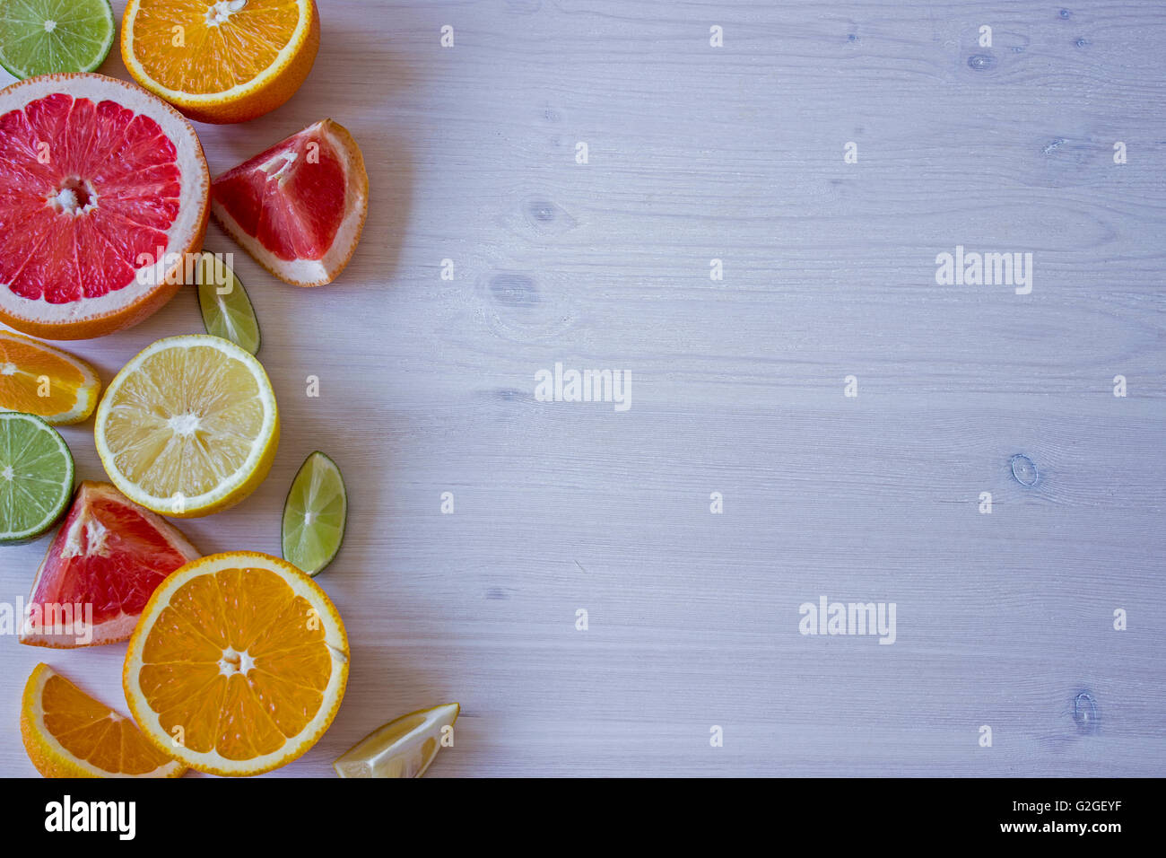 Citrus fruits. Over wood table background Stock Photo - Alamy