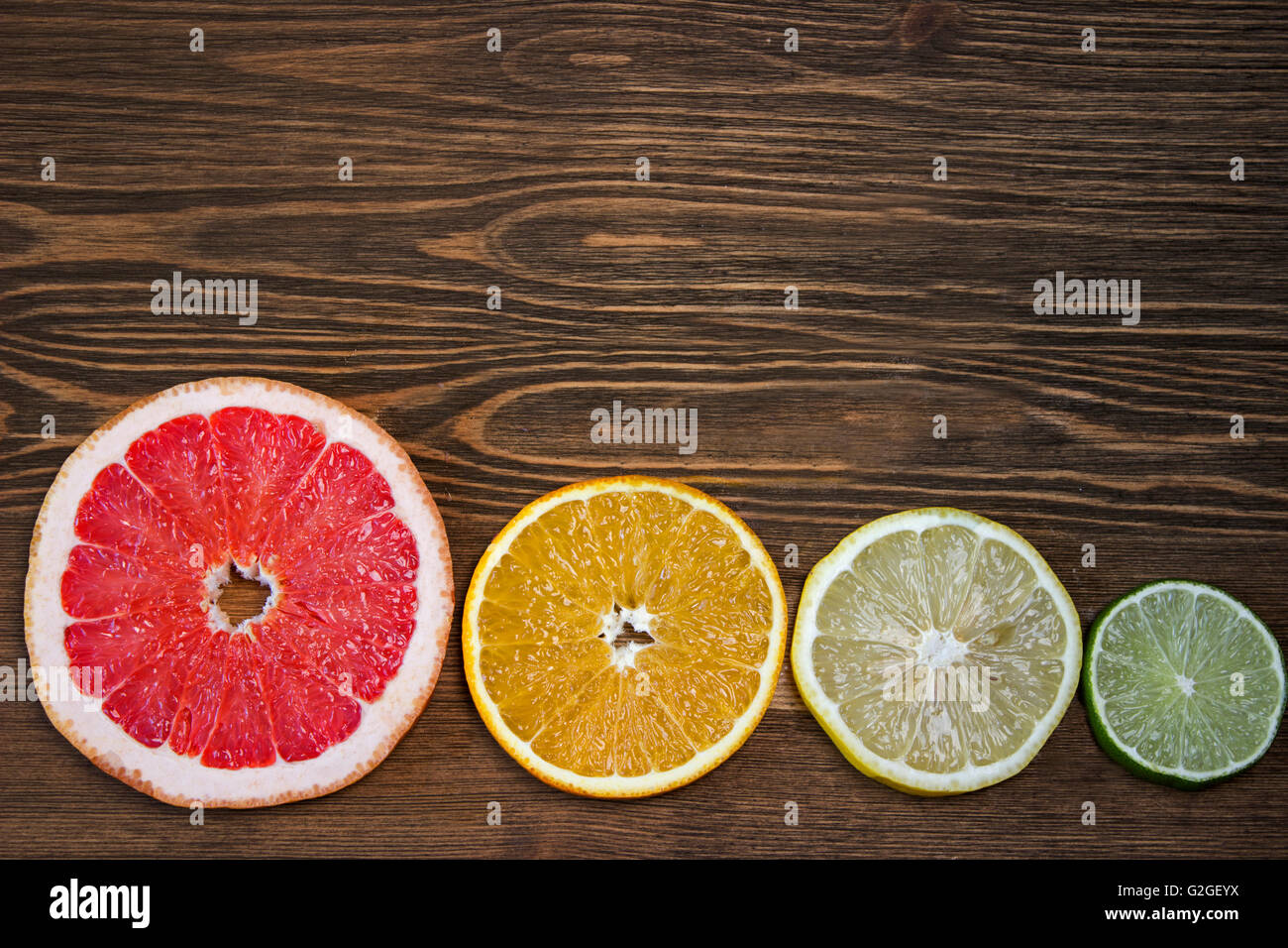 Citrus fruits. Over wood table background Stock Photo - Alamy