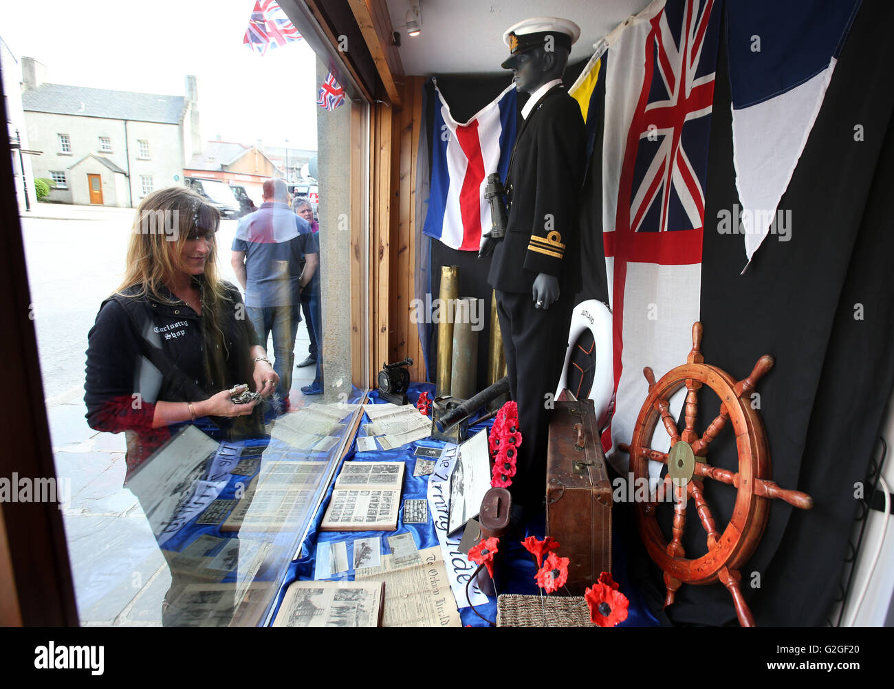 Shop owner Lynn Laughton views her window display in Kirkwall, Orkney ...