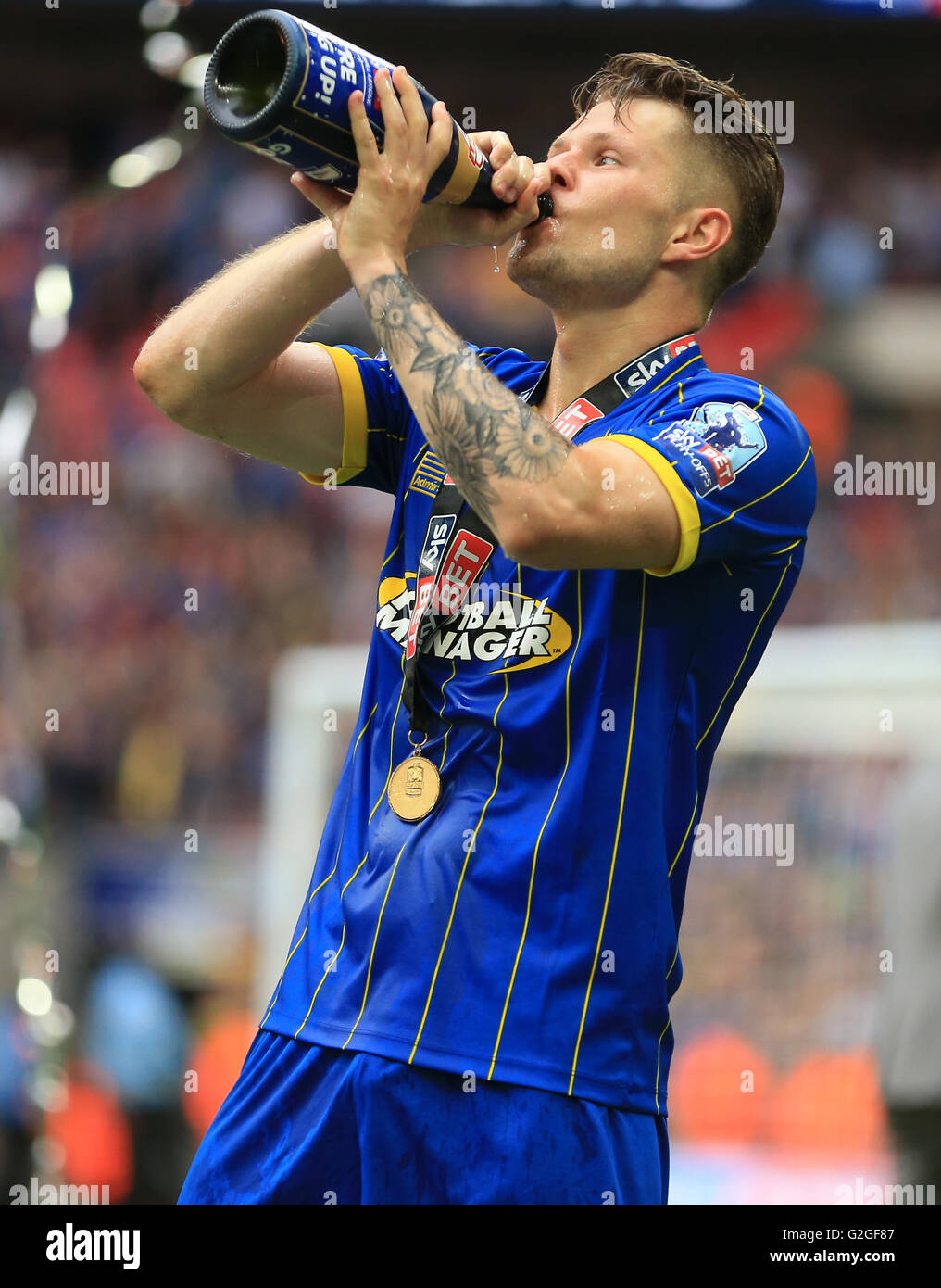 AFC Wimbledon's Jake Reeves celebrates with some champagne after ...