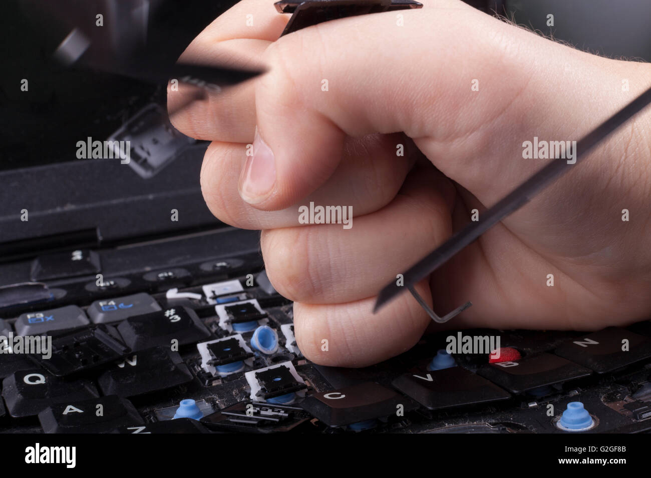 Woman braking laptop keyboard with her fist Stock Photo - Alamy