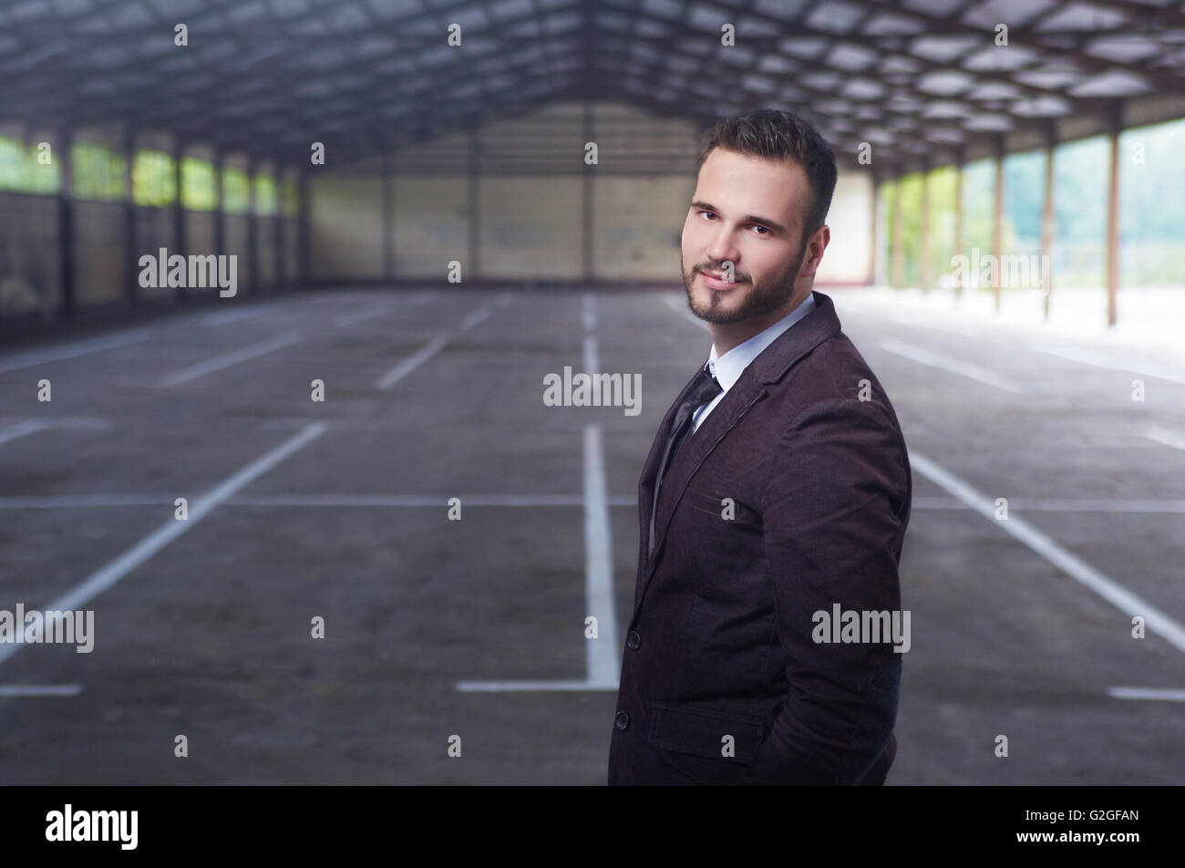 Smiling business man standing outside office building Stock Photo - Alamy