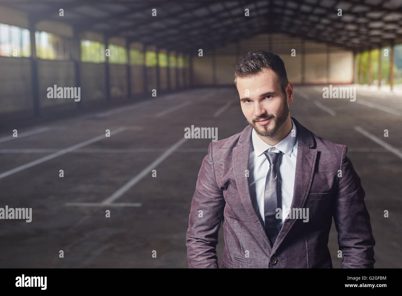 Smiling business man standing outside office building Stock Photo - Alamy