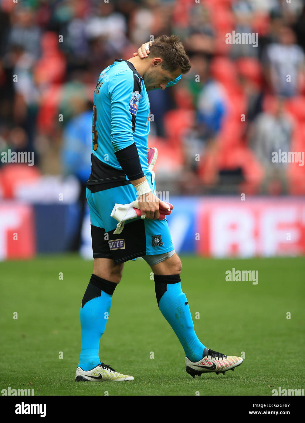 Plymouth Argyle goalkeeper Luke Mccormick walks away dejected after the ...