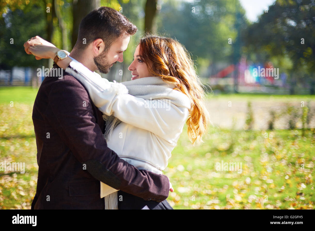 Young people kissing outdoors Stock Photo - Alamy