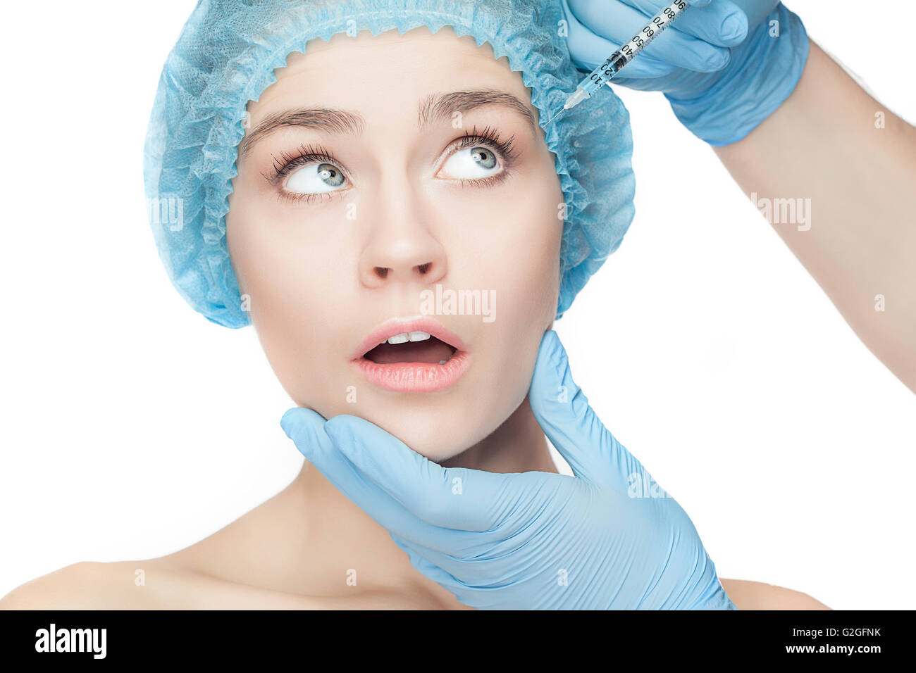 Attractive woman at plastic surgery with syringe in her face Stock ...