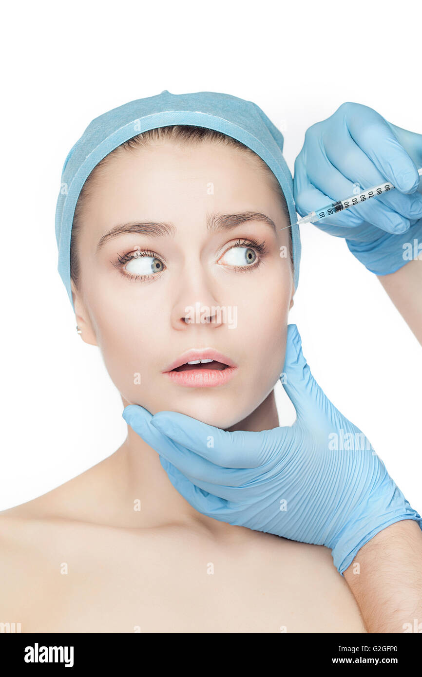 Attractive woman at plastic surgery with syringe in her face Stock ...