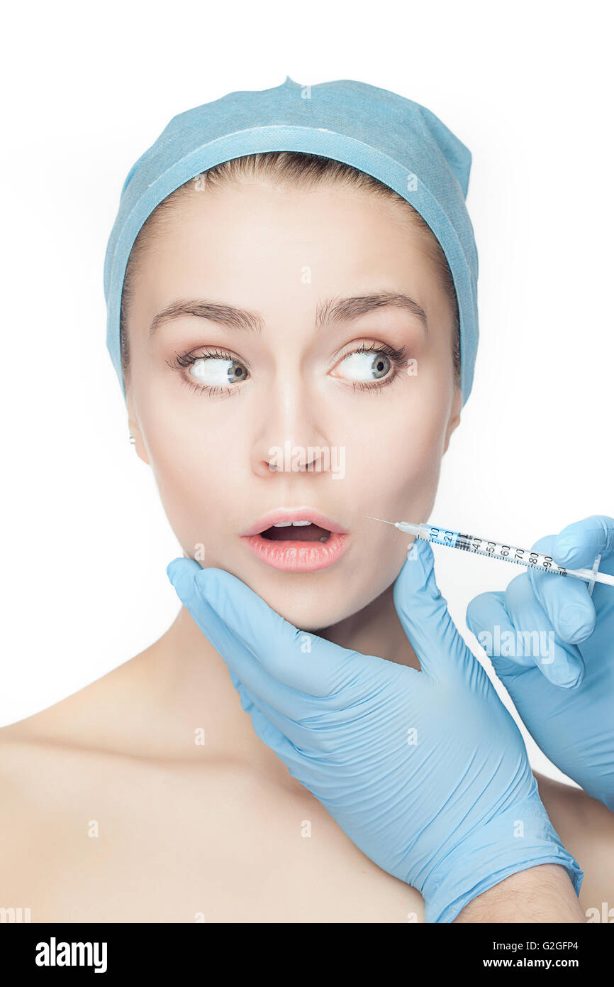 Attractive woman at plastic surgery with syringe in her face Stock ...