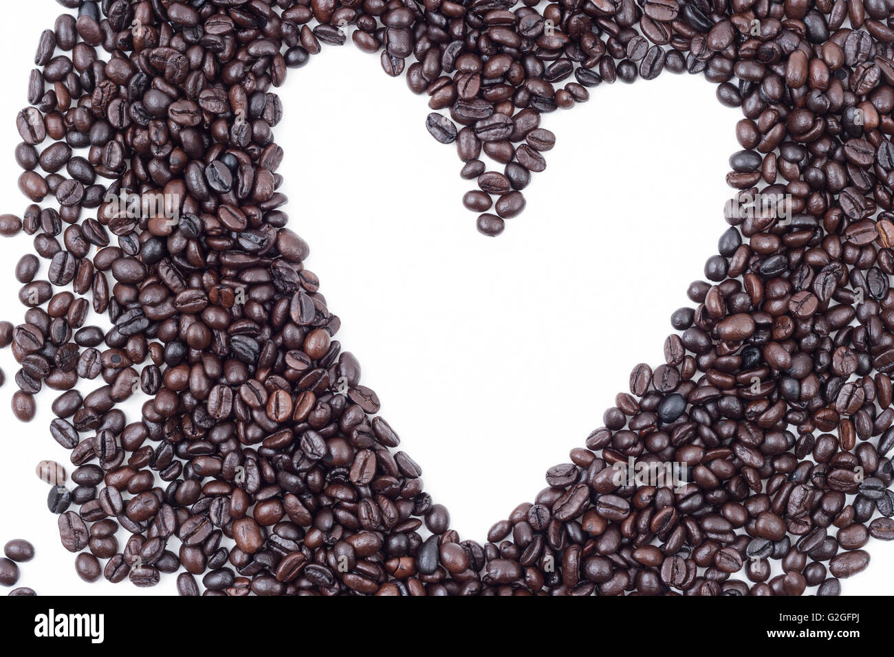 Heart shape made of coffee beans on white background Stock Photo - Alamy