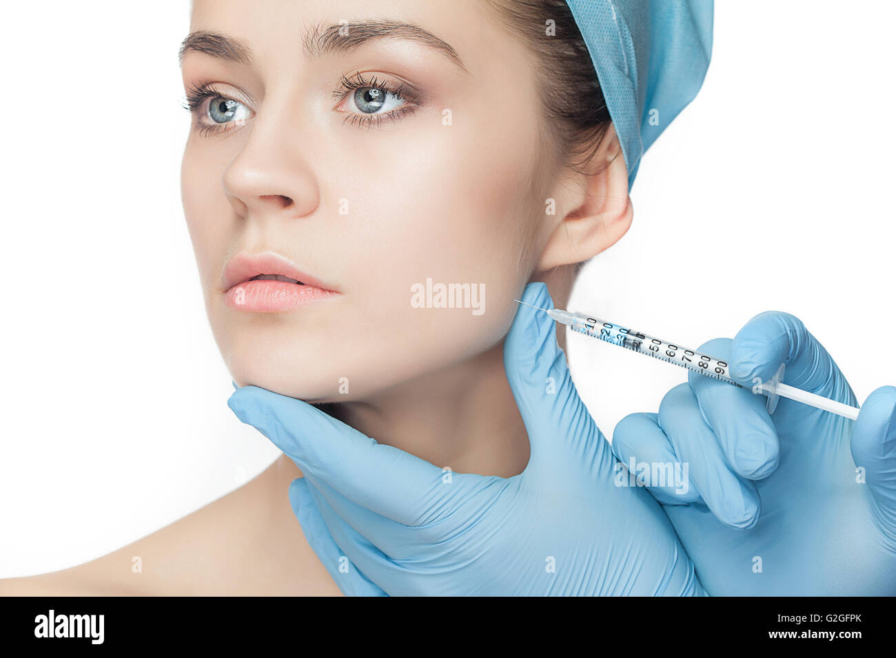 Attractive woman at plastic surgery with syringe in her face Stock ...