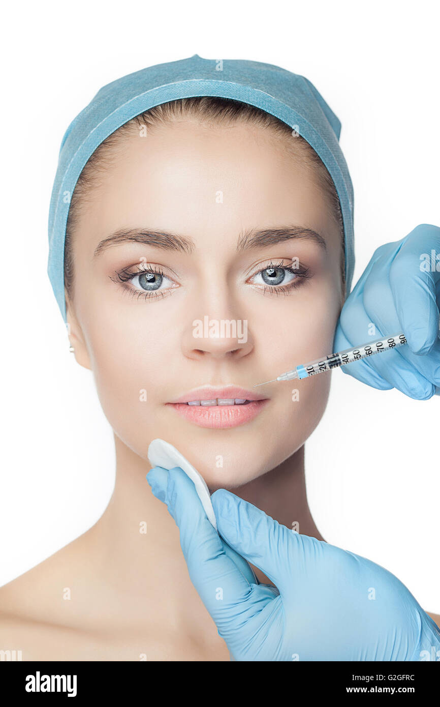 Attractive woman at plastic surgery with syringe in her face Stock ...