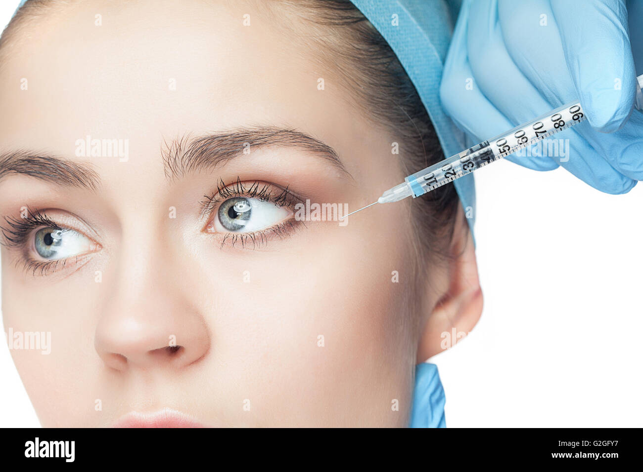 Attractive woman at plastic surgery with syringe in her face Stock ...