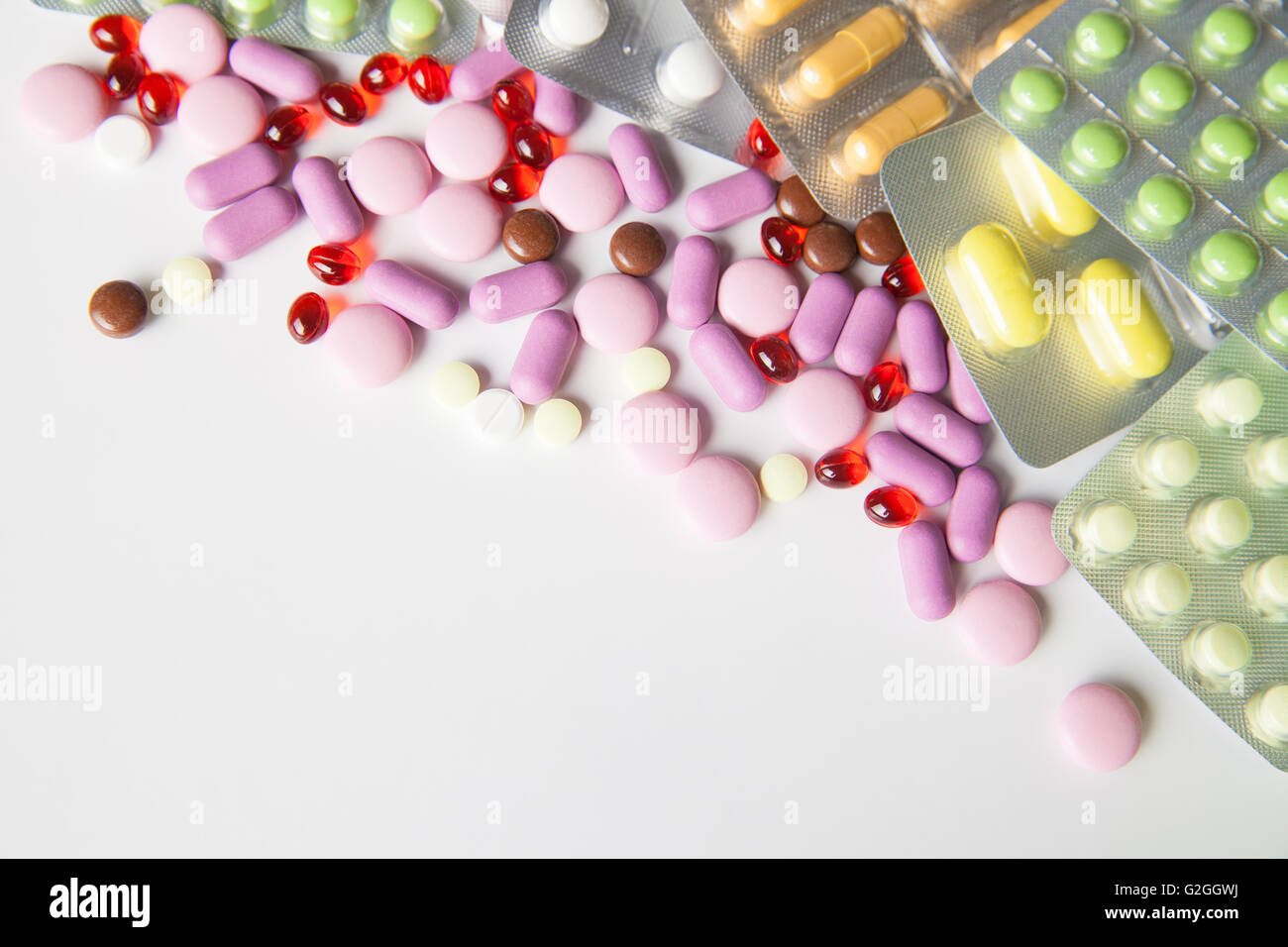 Colorful tablets on white background Stock Photo - Alamy