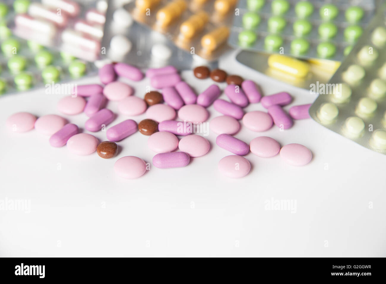 Colorful tablets on white background Stock Photo - Alamy